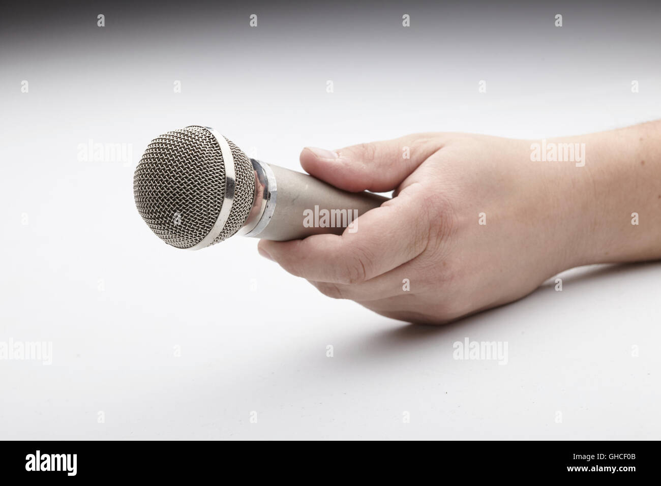 Microphone in a man's hand Stock Photo - Alamy