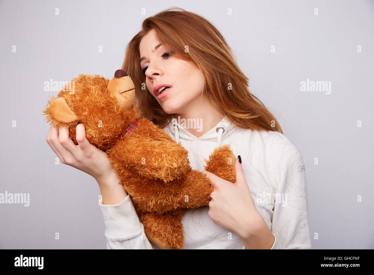 red-haired woman with a teddy bear Stock Photo - Alamy