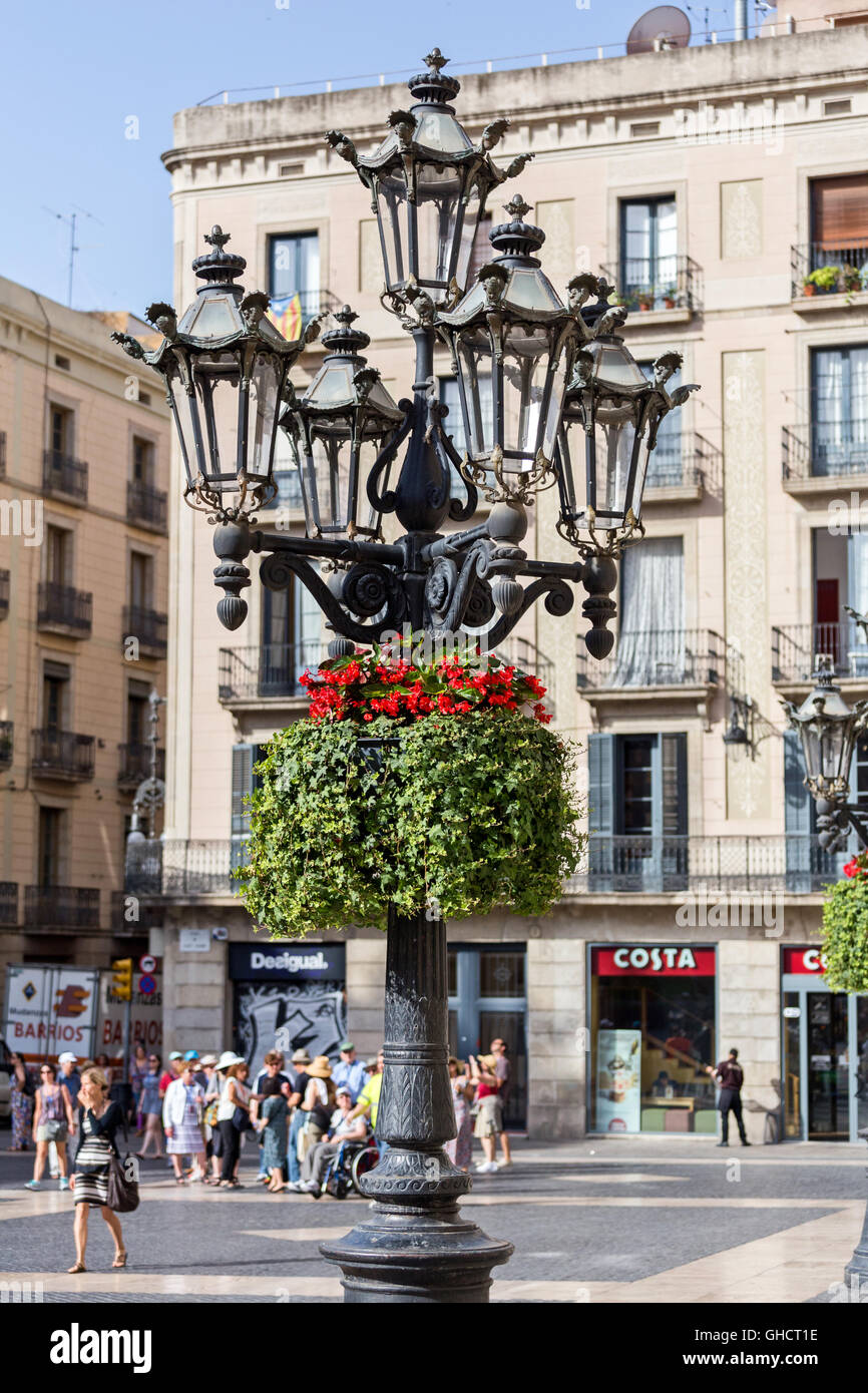 Historic looking lamp post in Barcelona with colorful plants and vines ...