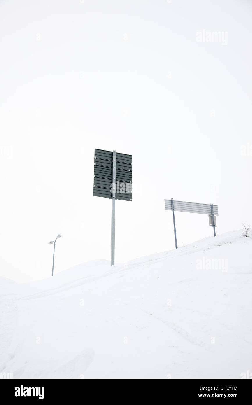 The back of two road signs and a street lamp at the top of an ...