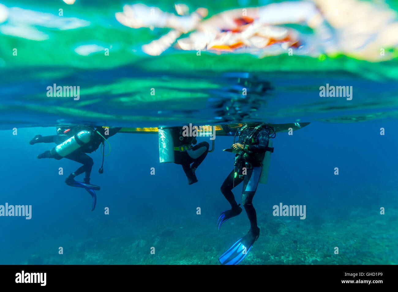 Group of Divers Climbing into Boat Stock Photo - Alamy