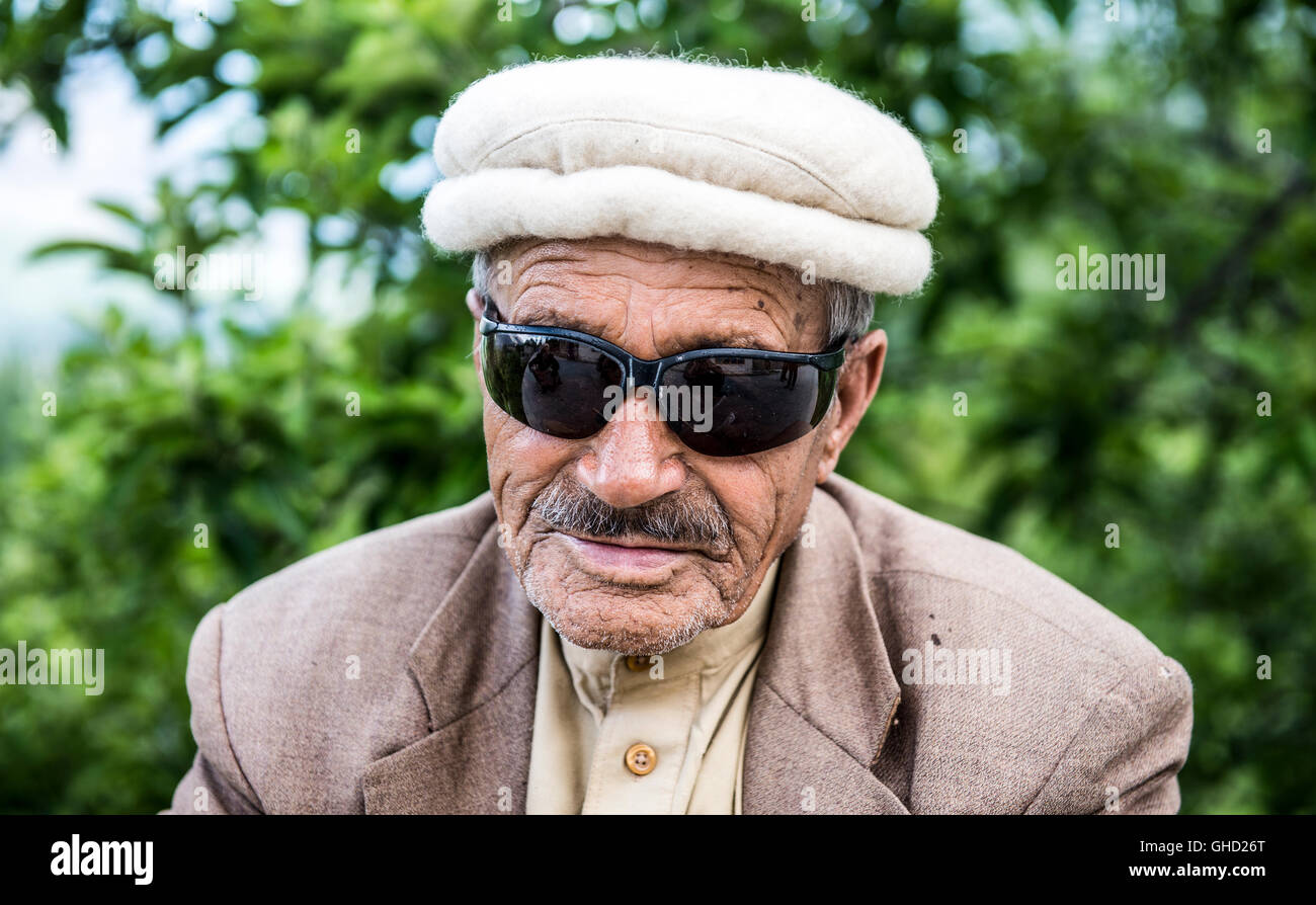 Man with moustache and dark glasses wearing traditional Hunza cap in ...