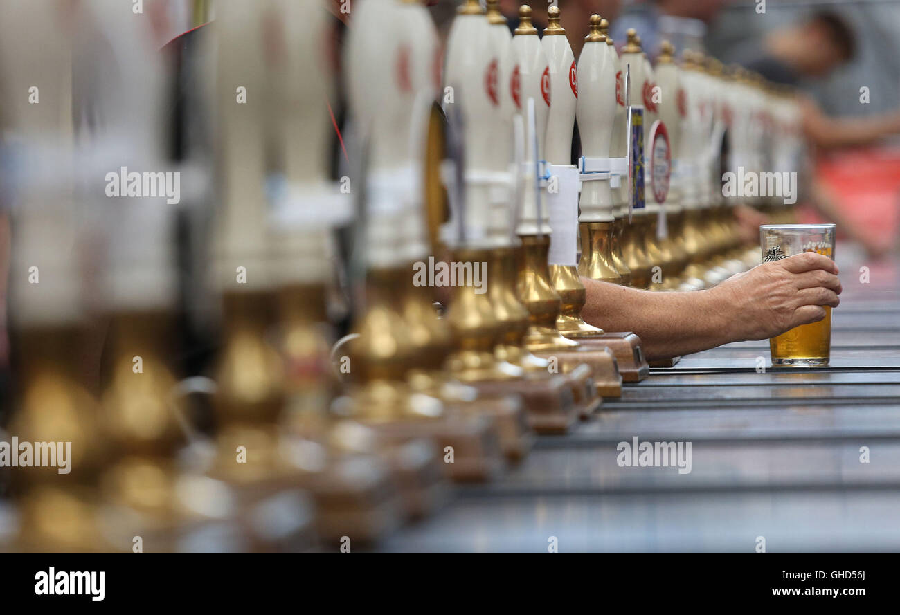 A half pint of real ale is passed across one of the bars at the Great ...