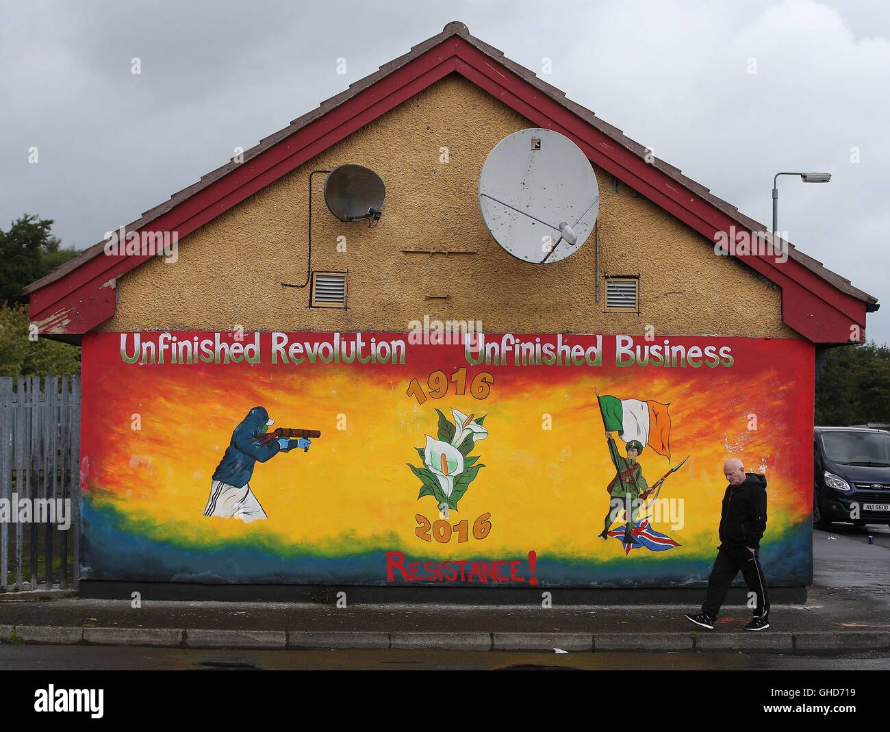 A man walks past a newly painted Republican mural commemorating the ...