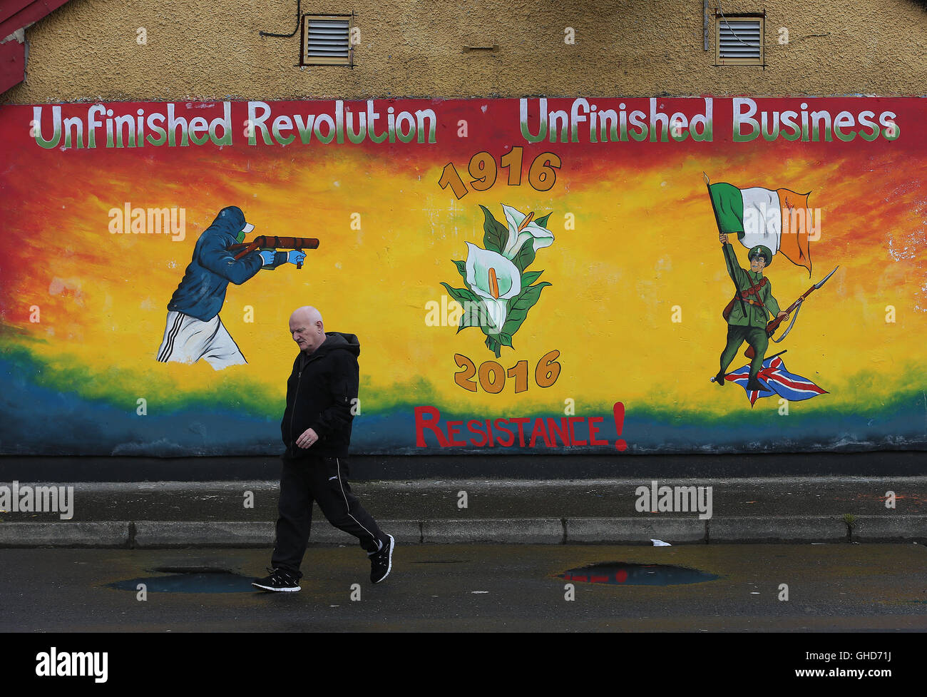 A man walks past a newly painted Republican mural commemorating the ...