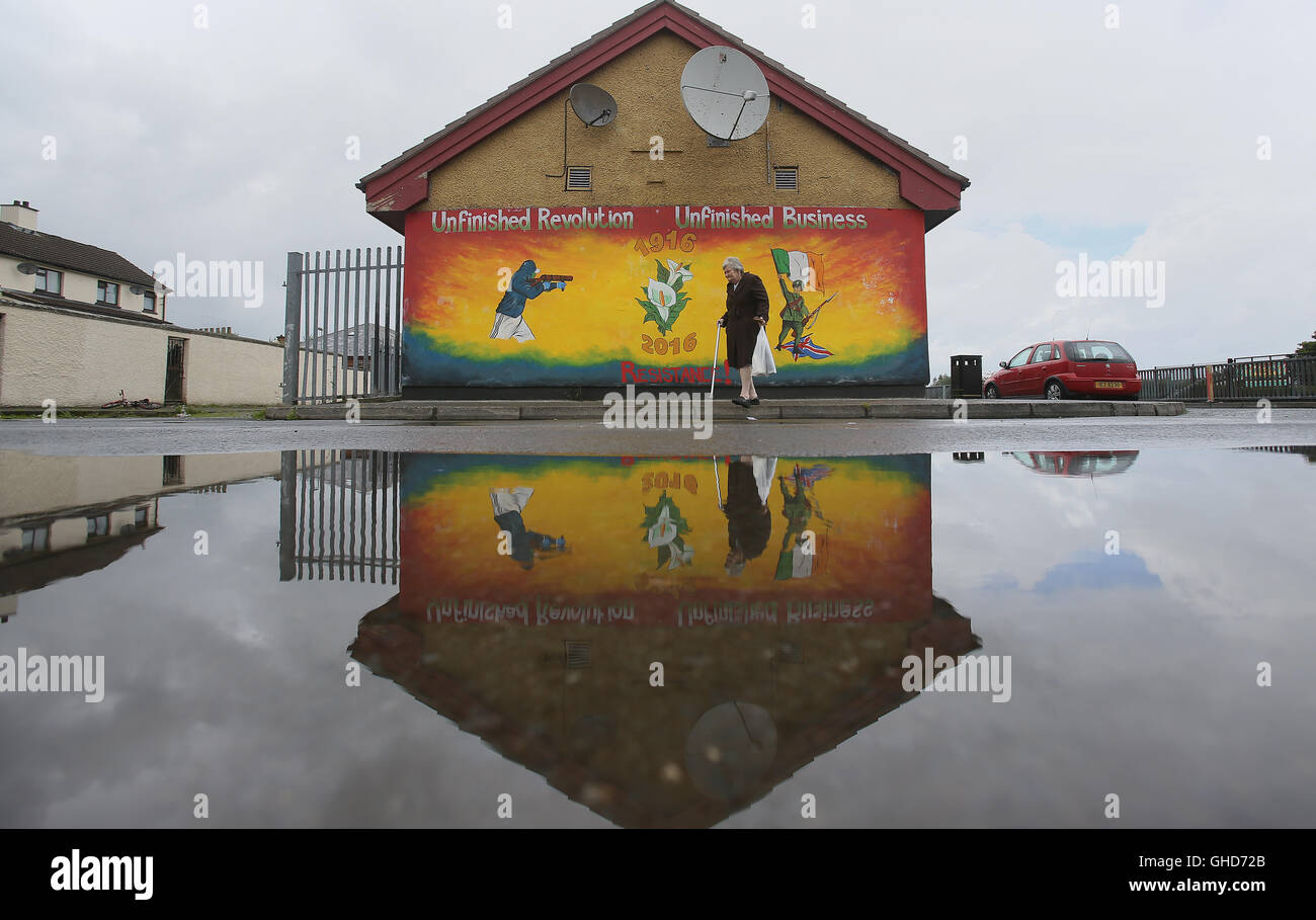 A woman walks past a newly painted Republican mural commemorating the ...