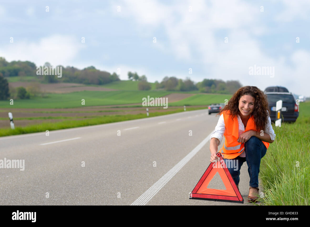 Woman putting triangle sign car hi-res stock photography and images - Alamy