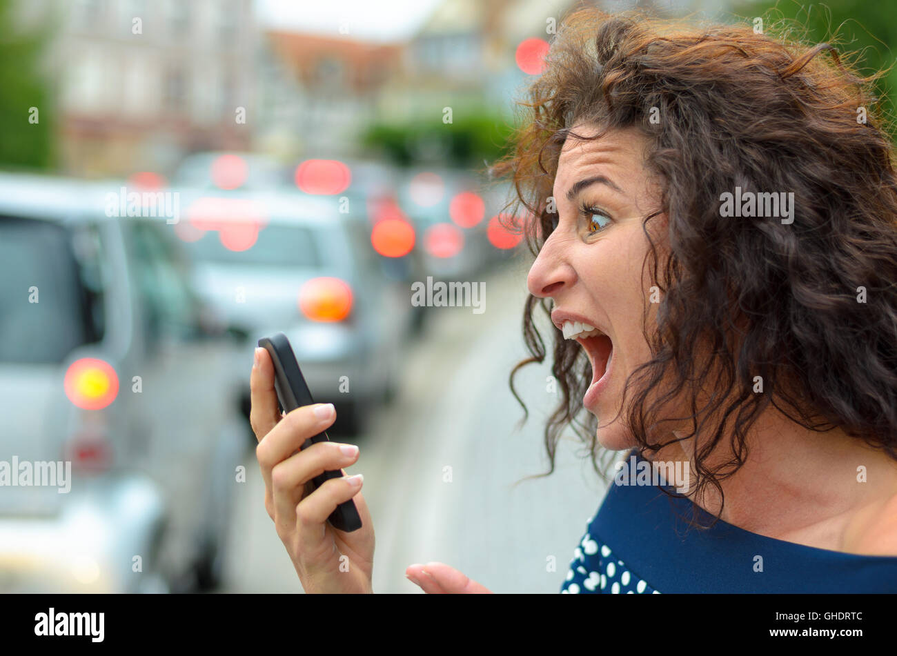 Aghast attractive young woman with a horrified expression looking at a ...