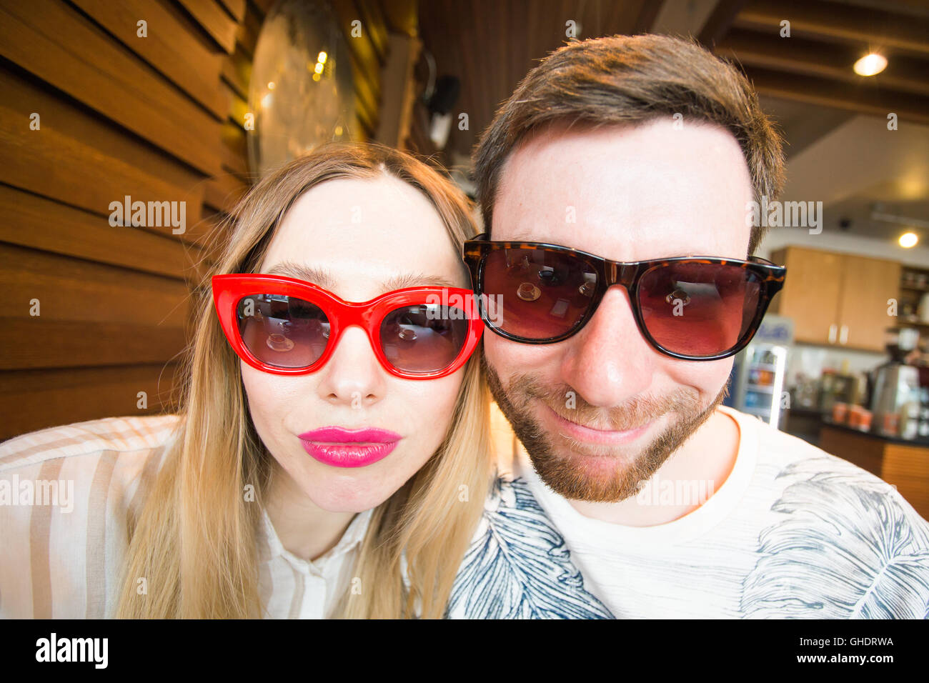 Happy couple fooling around in funny glasses Stock Photo - Alamy