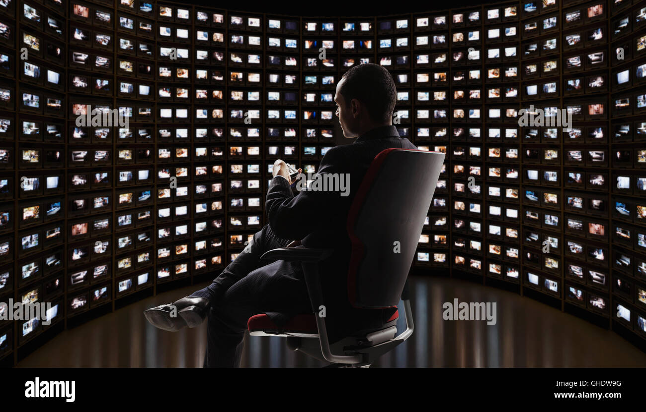 Man watching video on monitors Stock Photo - Alamy