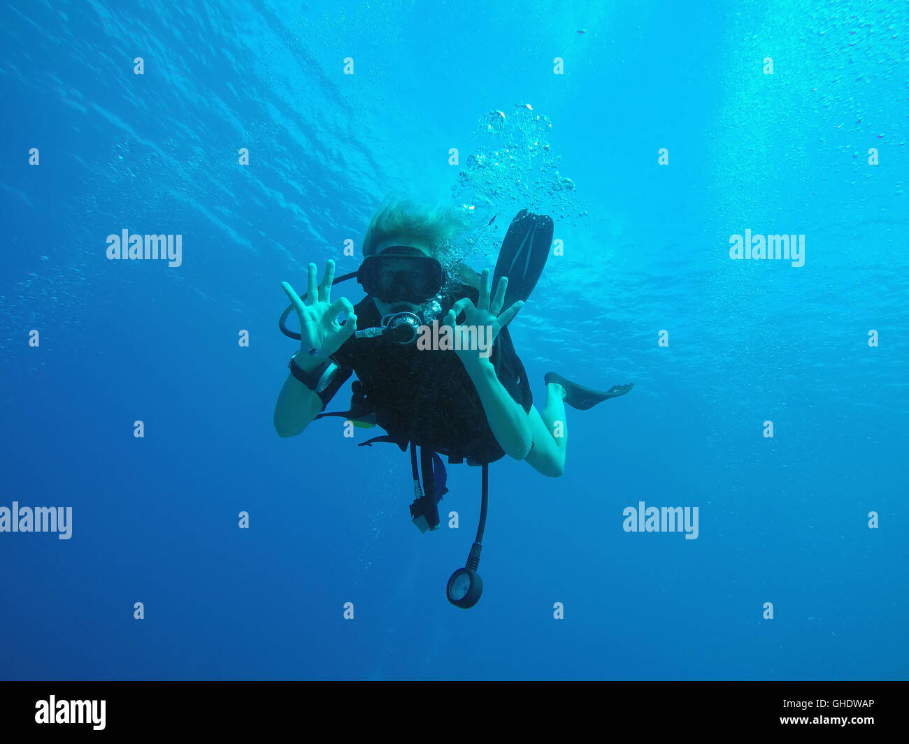 Portrait of confident scuba diver gesturing okay underwater Stock Photo ...