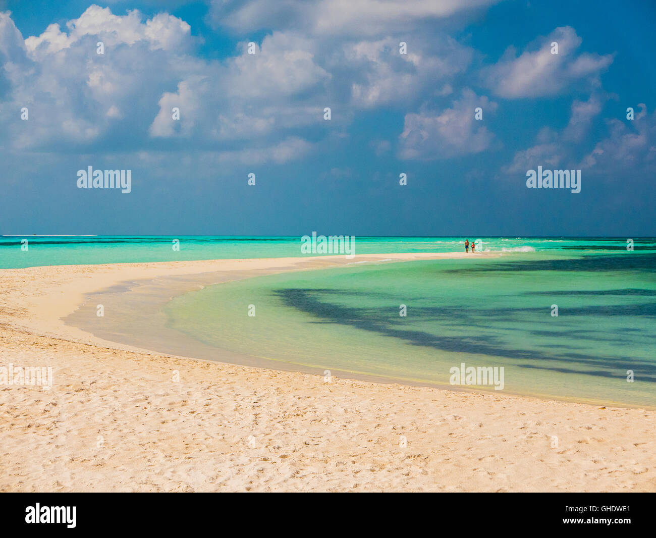 People in distance walking on tropical beach, Maldives Stock Photo - Alamy