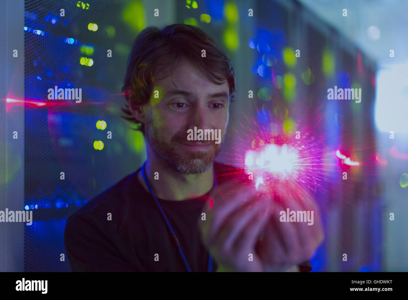 Server room technician holding illuminated computer chip Stock Photo ...