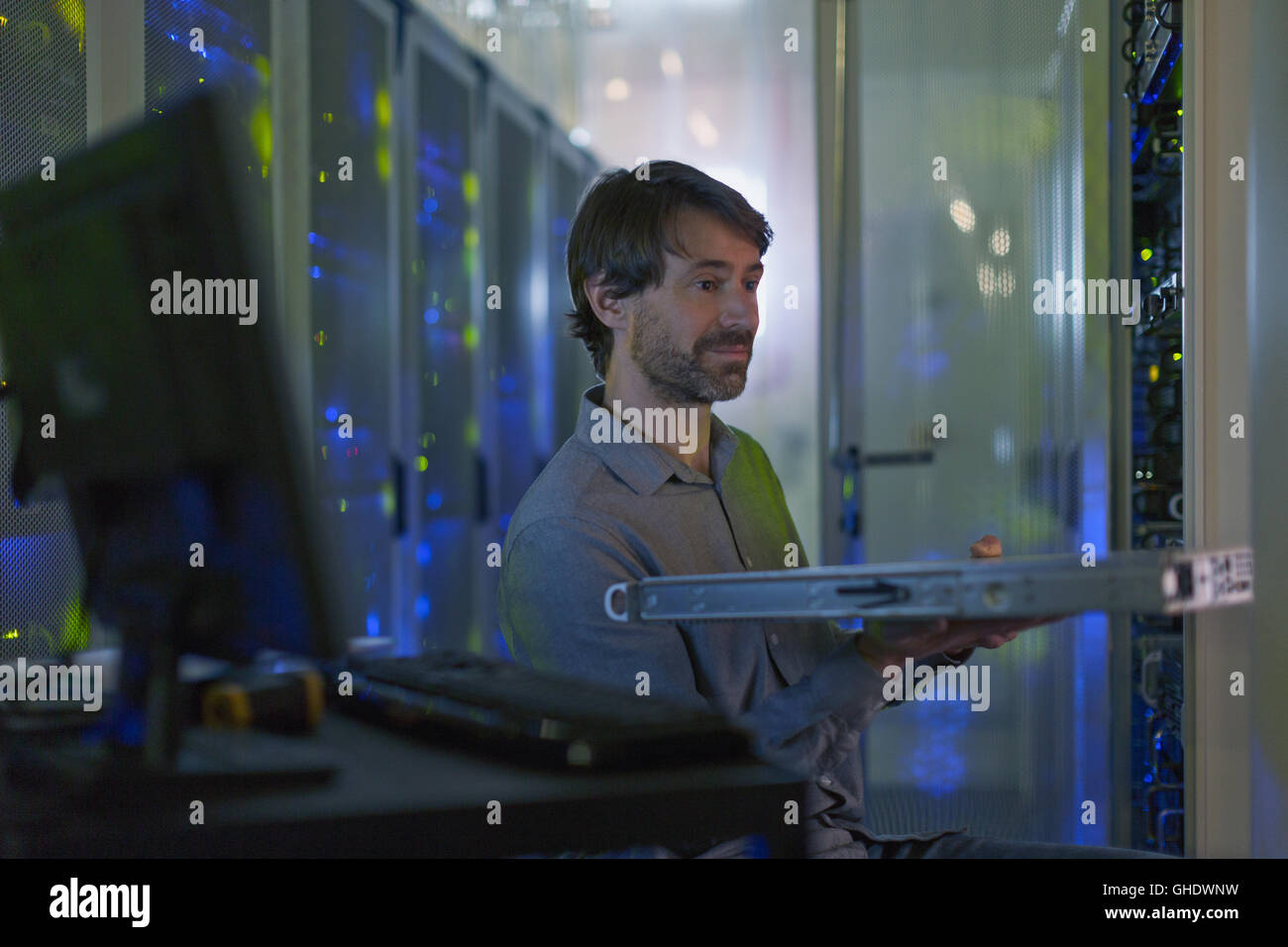 Server room technician removing rack from cabinet panel Stock Photo - Alamy