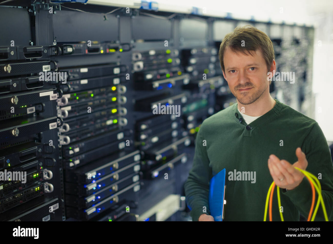 Portrait confident server room technician holding cable Stock Photo - Alamy
