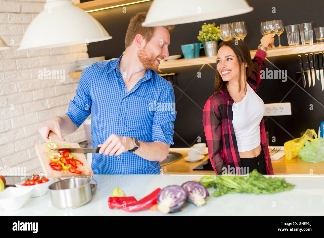 Couple cooking together in the modern kitchen at home Stock Photo - Alamy