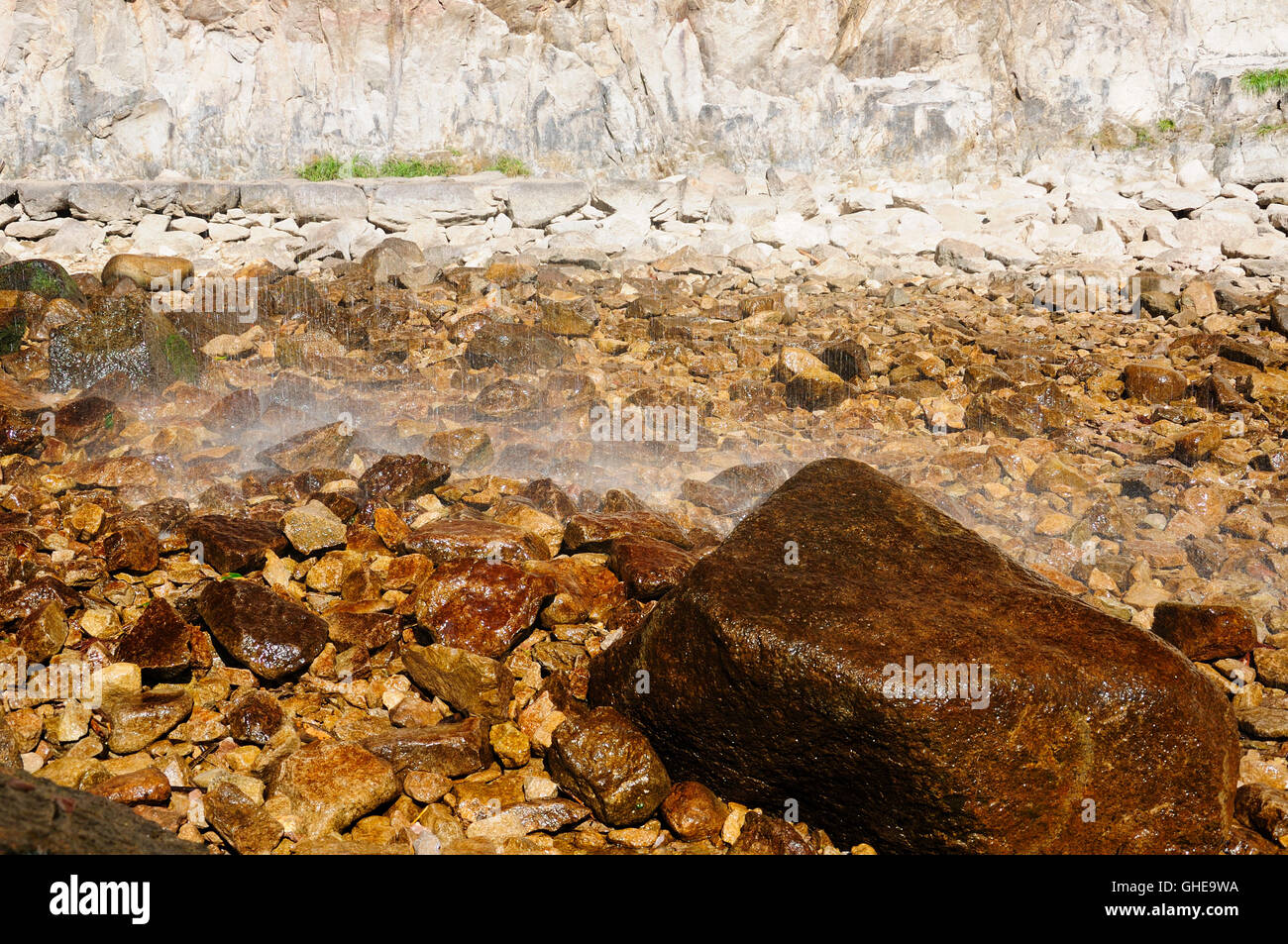 Water raining down from DaLong waterfall on to the rocks and boulders ...