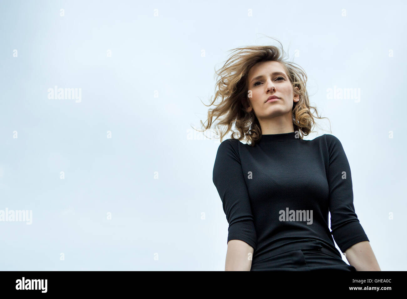 Beautiful woman with a serious expression on her face looking straight ...