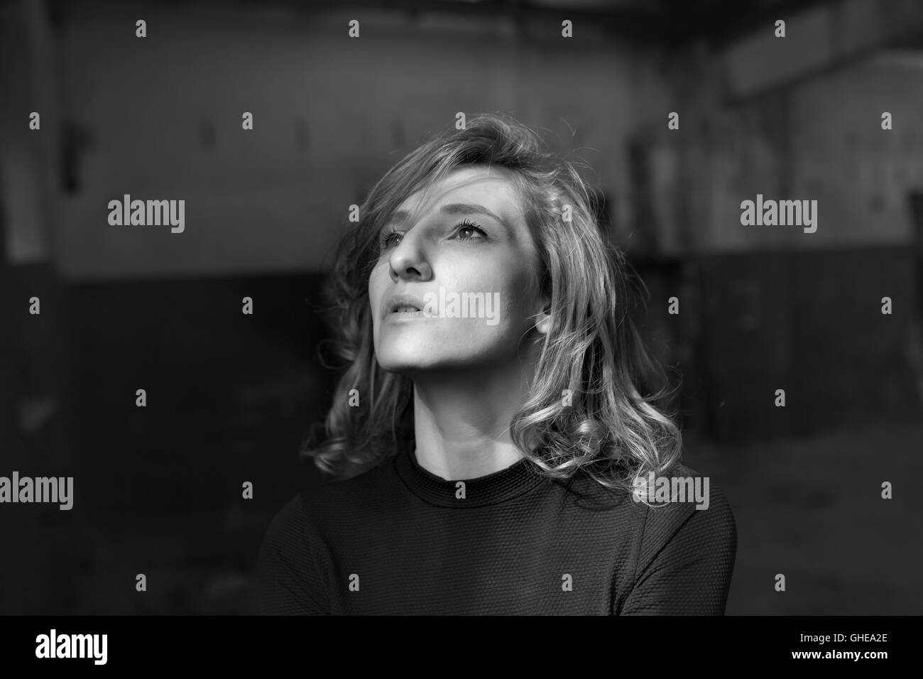 Beautiful woman with a serious expression on her face looking straight ...