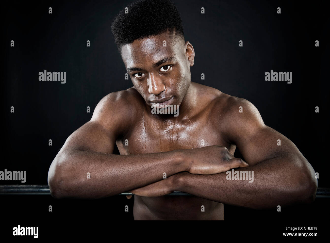 Sportsman athlete sweating wet face portrait after exercise arms folded ...