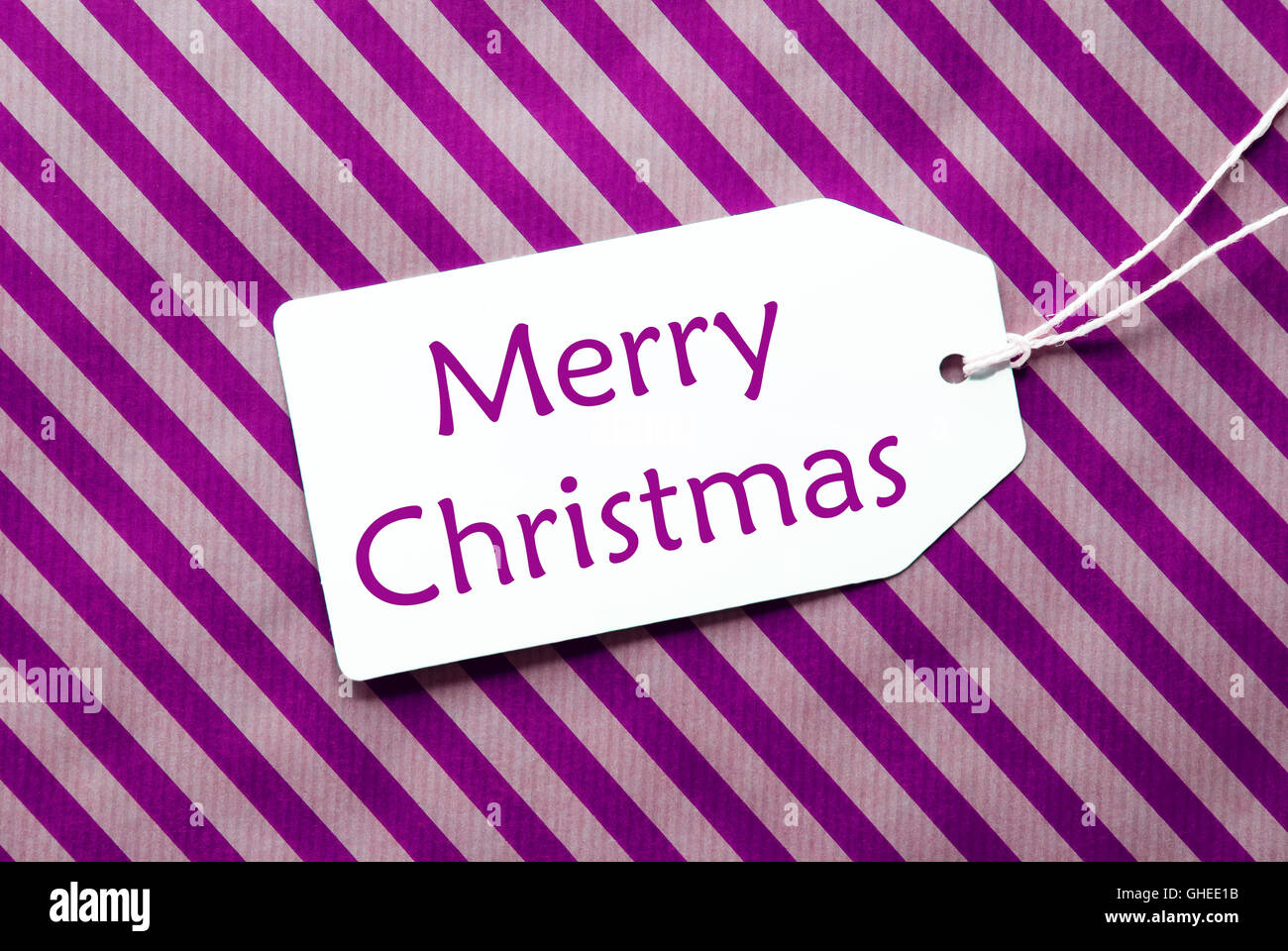 Label On Purple Wrapping Paper, Text Merry Christmas Stock Photo - Alamy