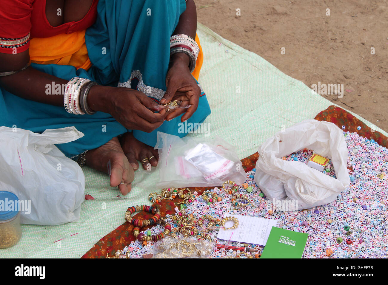 An Indian woman making and selling bracelets from beads Stock Photo - Alamy