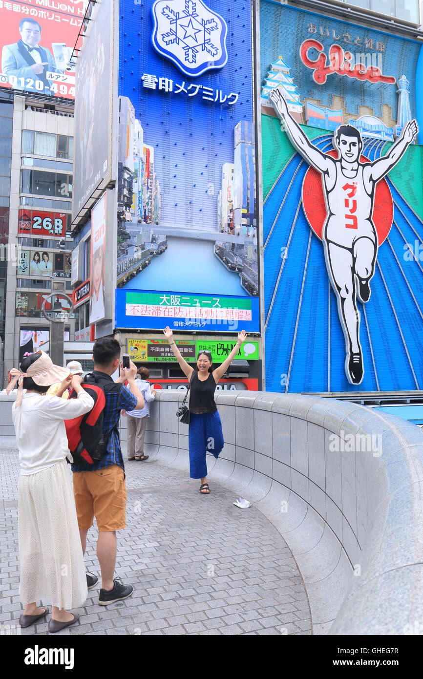 People pose in front of Glico Man sign in Dotonbori in Osaka Japan ...