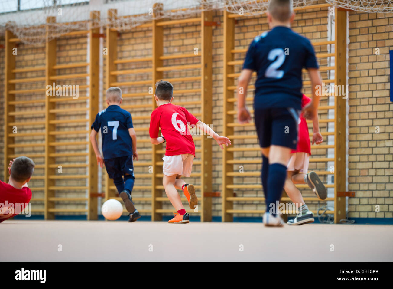 Boys kicking ball at goal Stock Photo - Alamy
