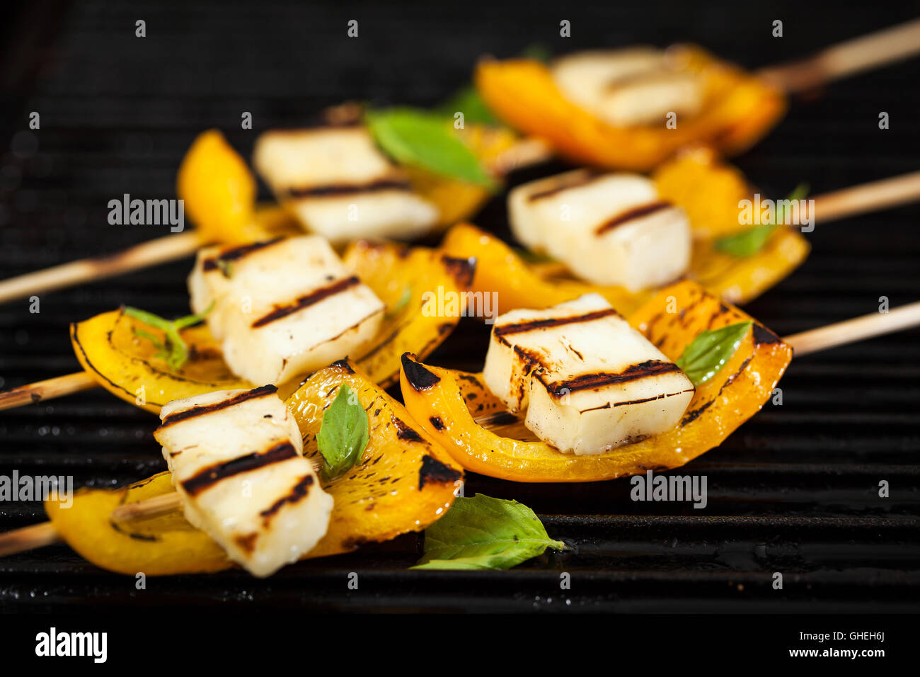 Halloumi cheese and bell pepper skewers appetizer on grill Stock Photo ...