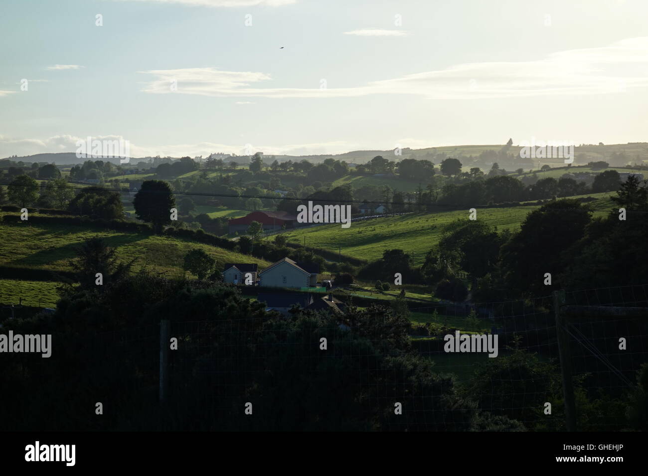 Evening sunlit valley landscape Stock Photo - Alamy