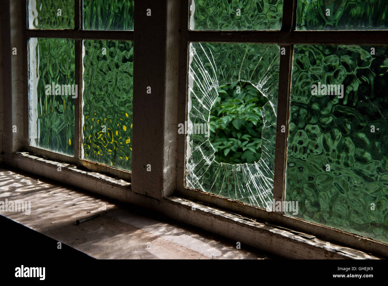 Broken window at De Salis Hall within the closed Harperbury Hospital ...