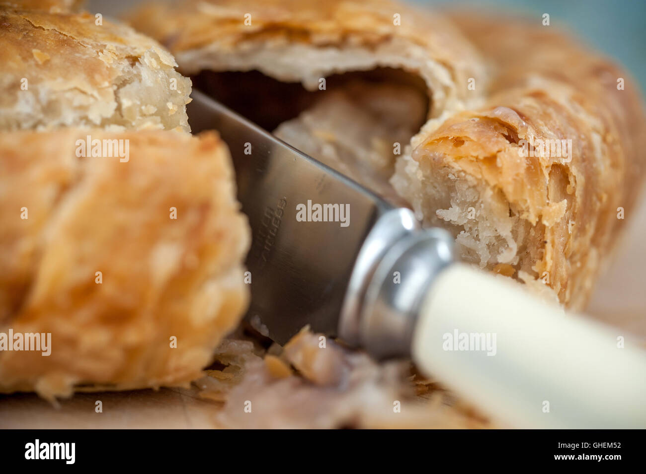 Cutting into a traditional Cornish pasty with a steel and bone-handled ...