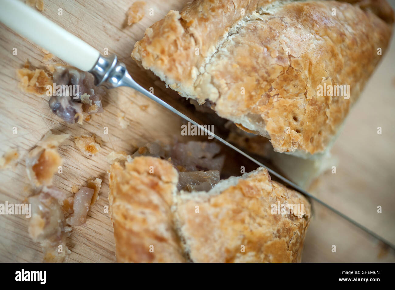 Cutting into a traditional Cornish pasty with a steel and bone-handled ...