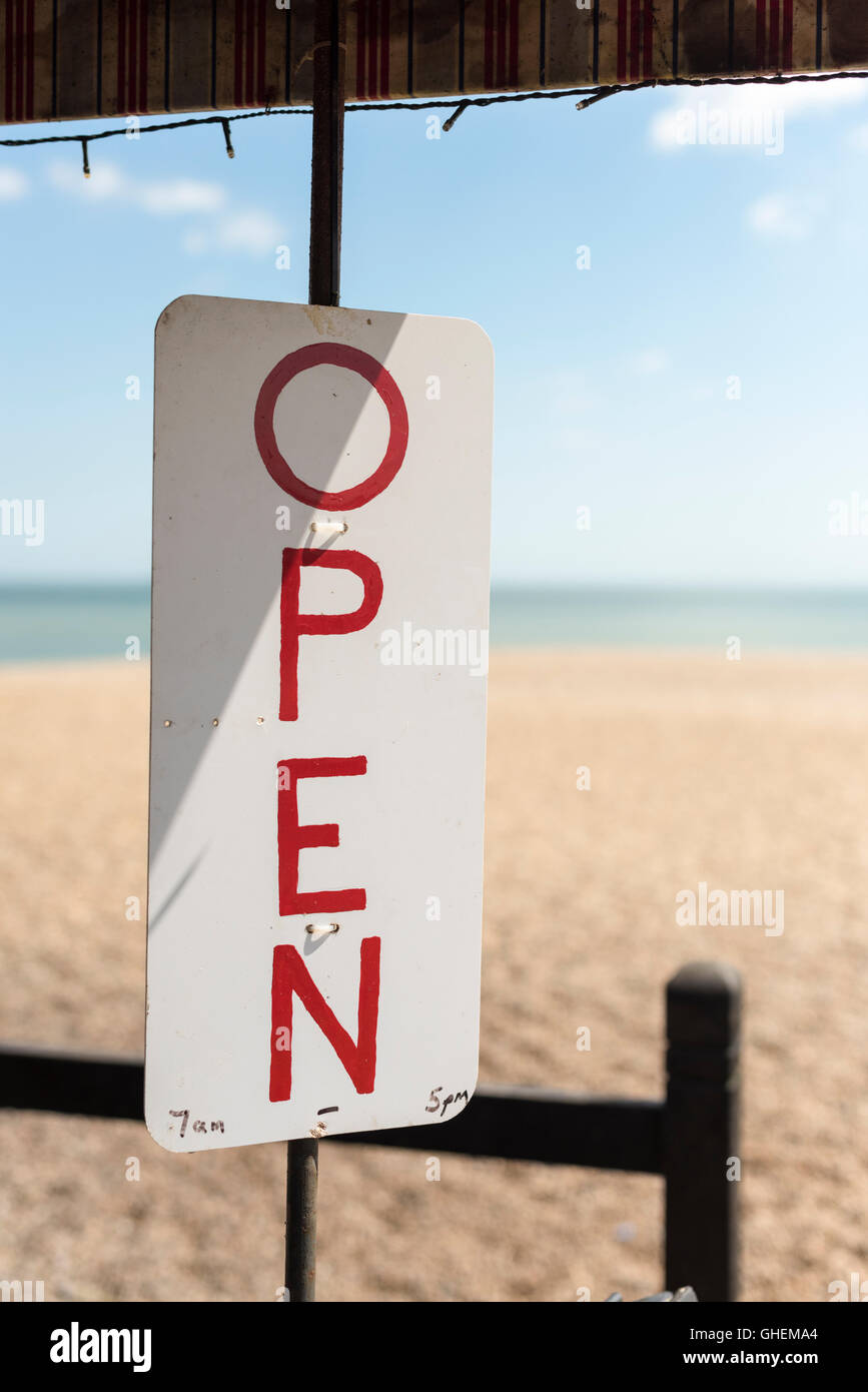 A hand made and hand painted open sign on a beach shop Stock Photo - Alamy