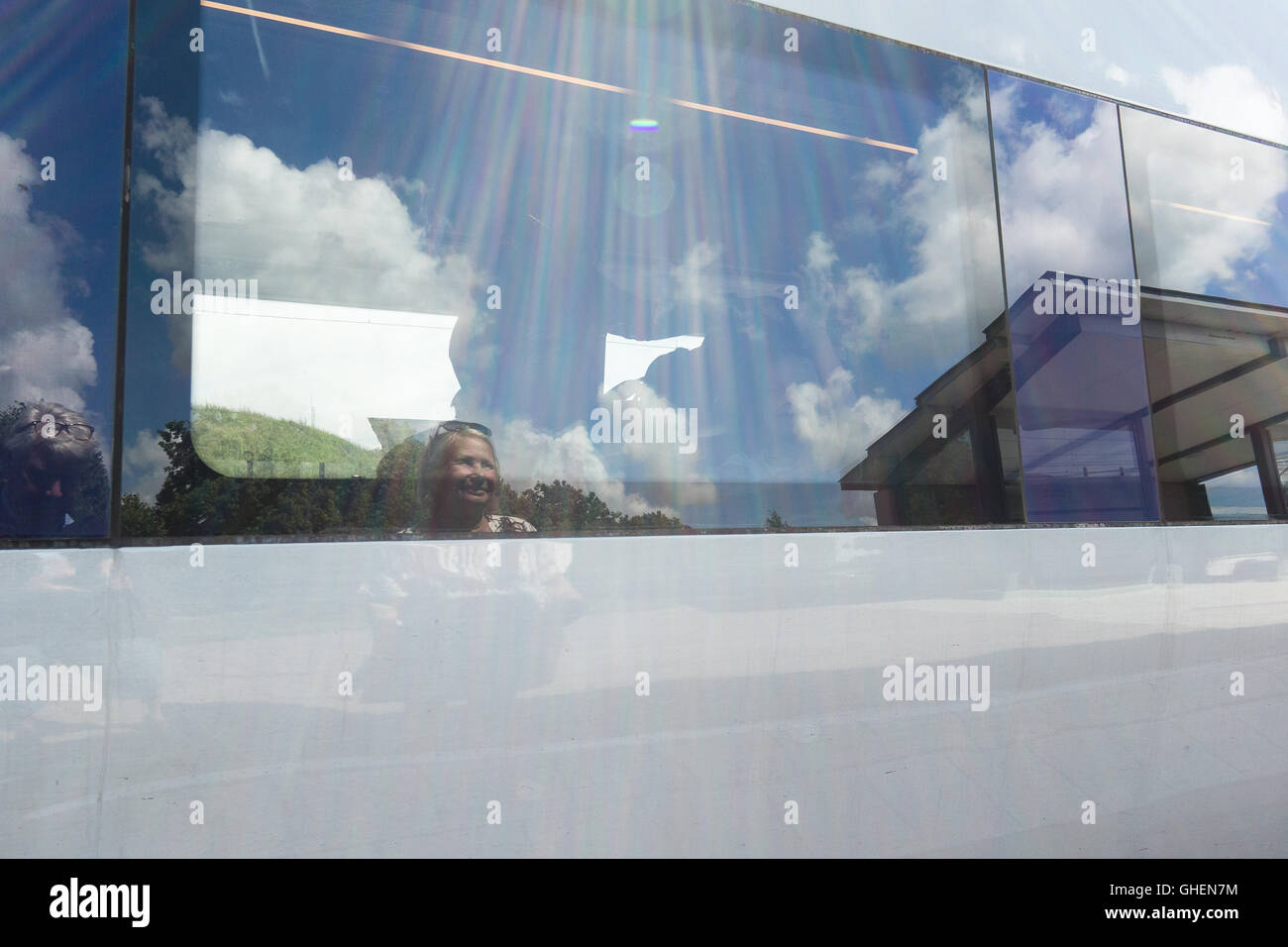 Woman waves goodbye, Sunlight reflections in a train window Stock Photo ...