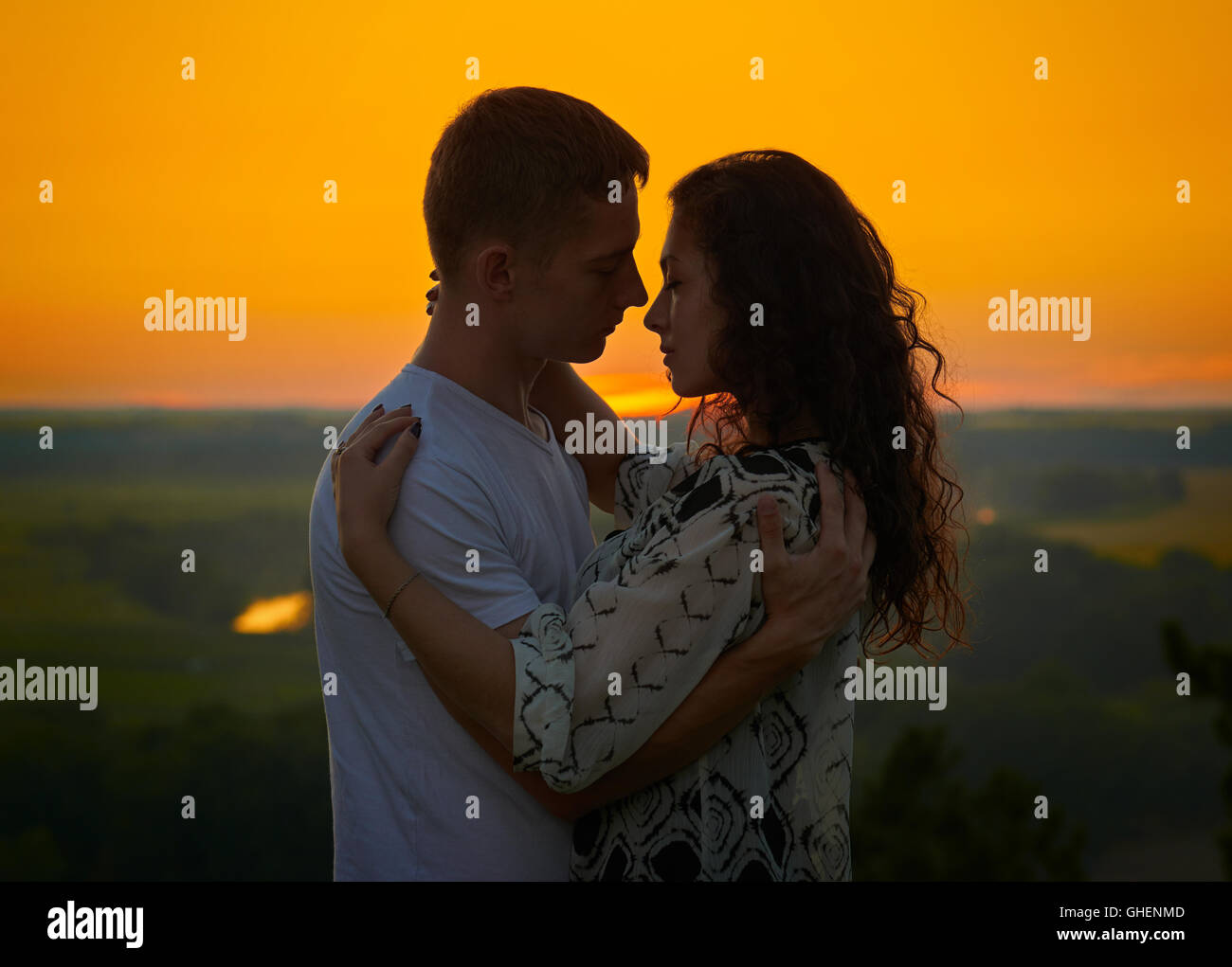 romantic couple at sunset on outdoor, beautiful landscape with bright ...