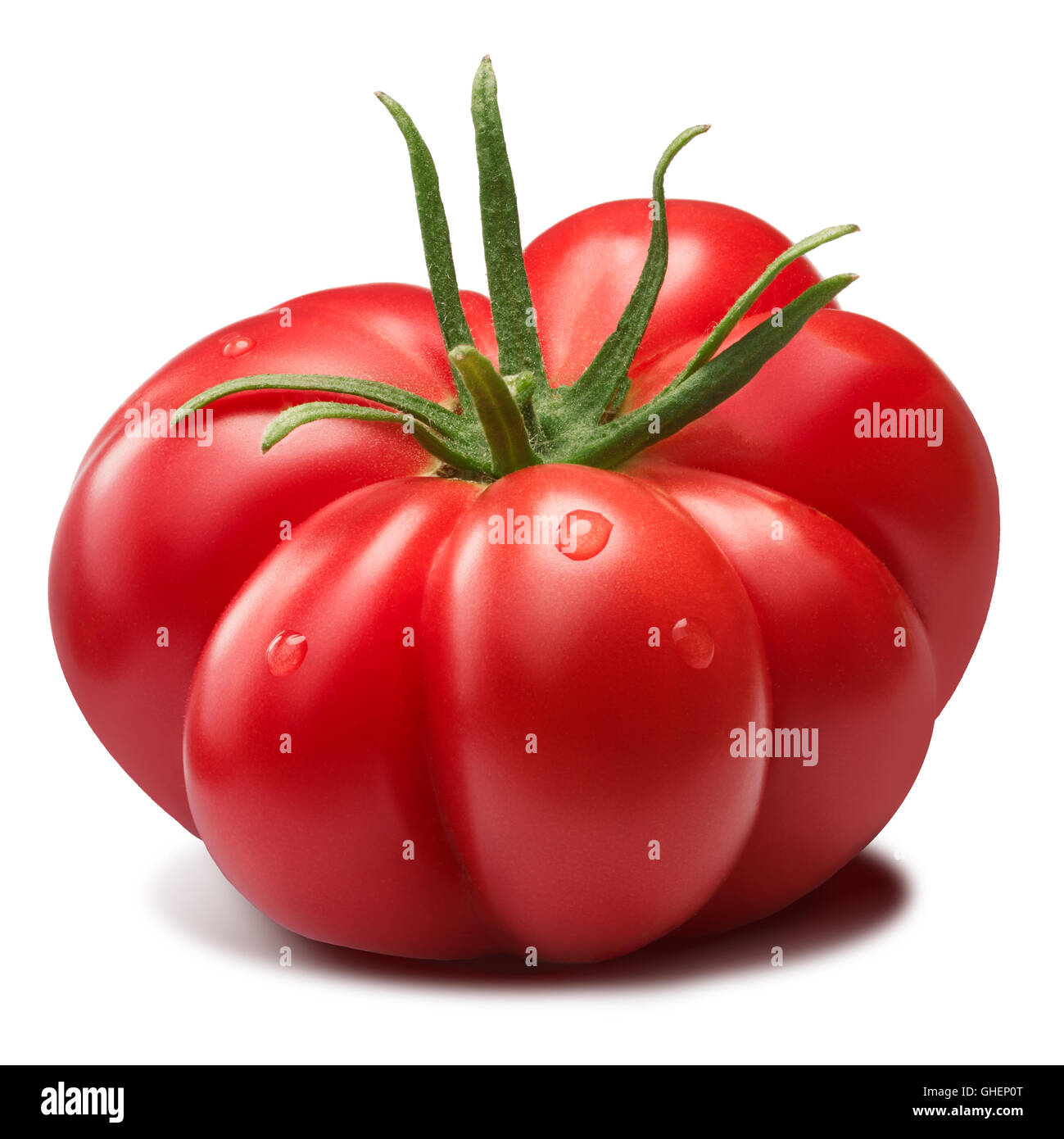 Ribbed heirloom tomato with sepal. Clipping paths, shadow separated ...