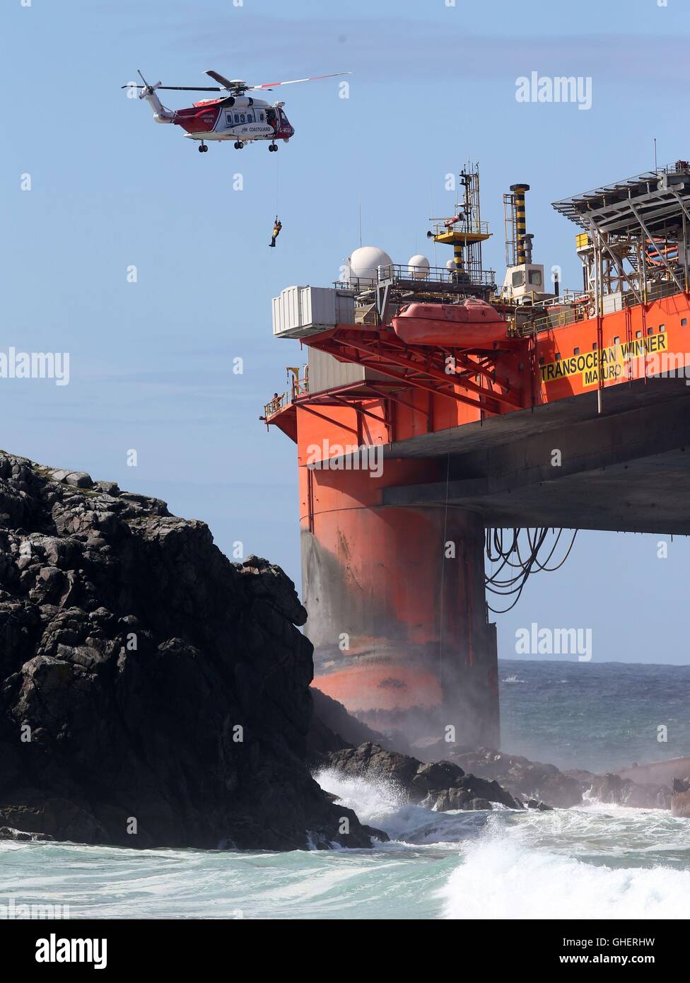 A coastguard helicopter winches a salvage expert onboard the Transocean ...