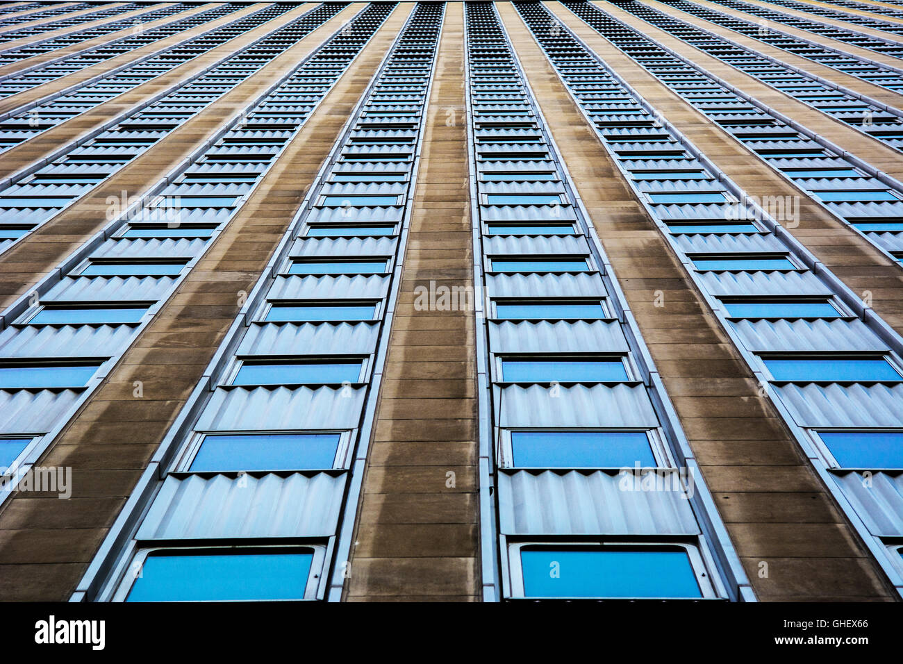Upward view of tall skyscraper creating distorted pattern in the ...
