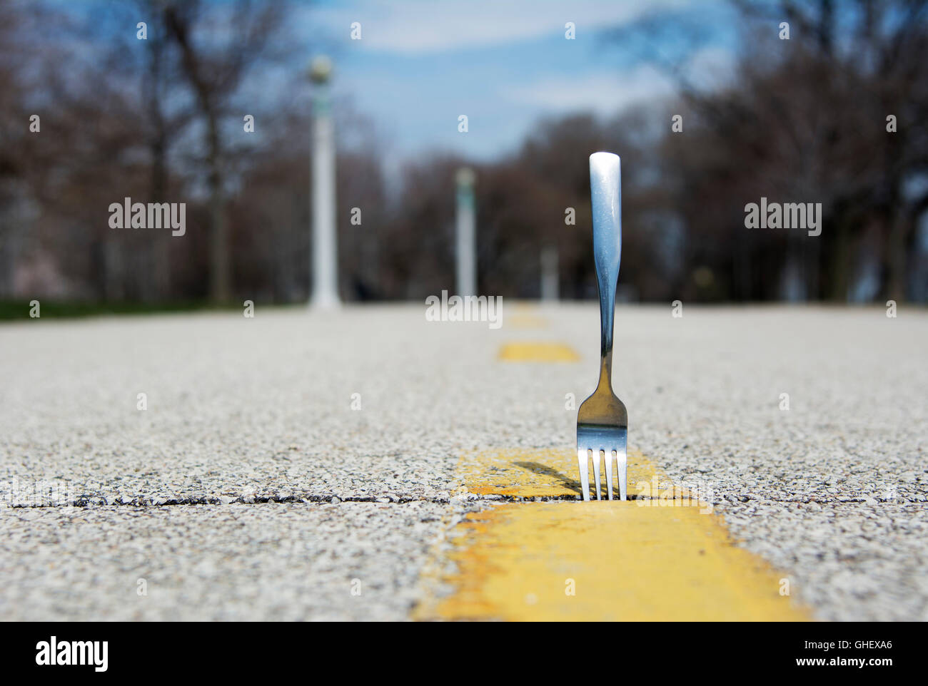 Fork stuck in the cement crack of the bike trail through the park Stock ...