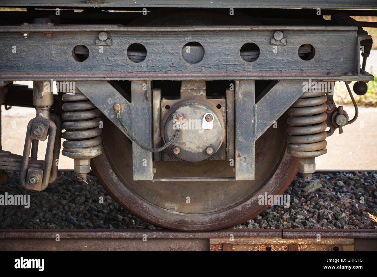 Dark railway carriage wheel with suspension details, closeup frontal ...