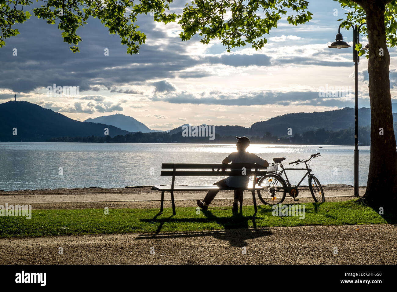 Man sitting on bench Stock Photo - Alamy