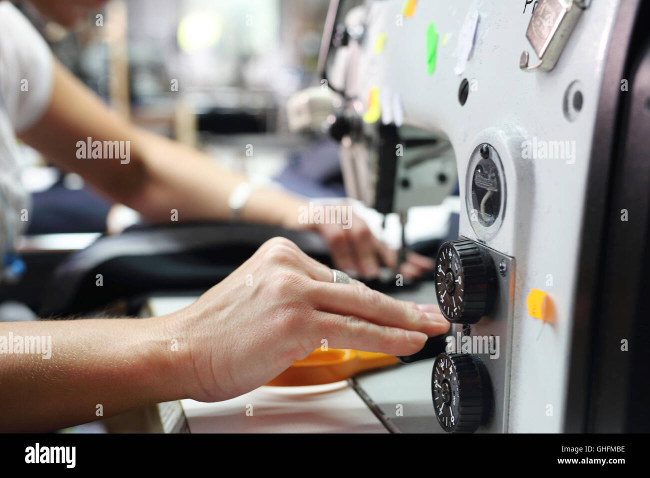 Production of clothes, sewing on a machine Stock Photo - Alamy