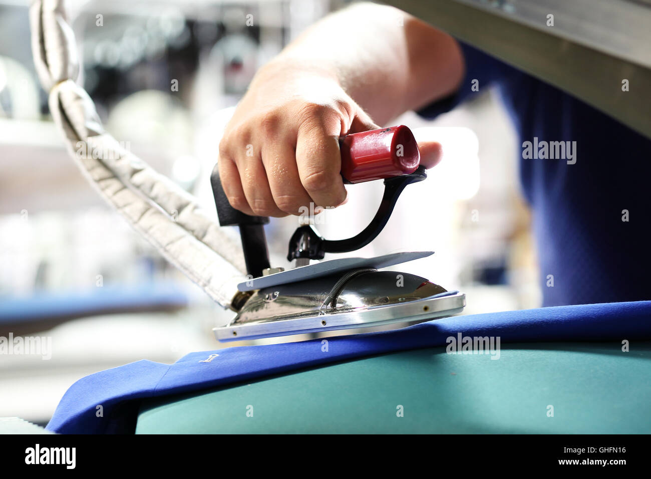 Presser in sewing clothes pressed Stock Photo - Alamy