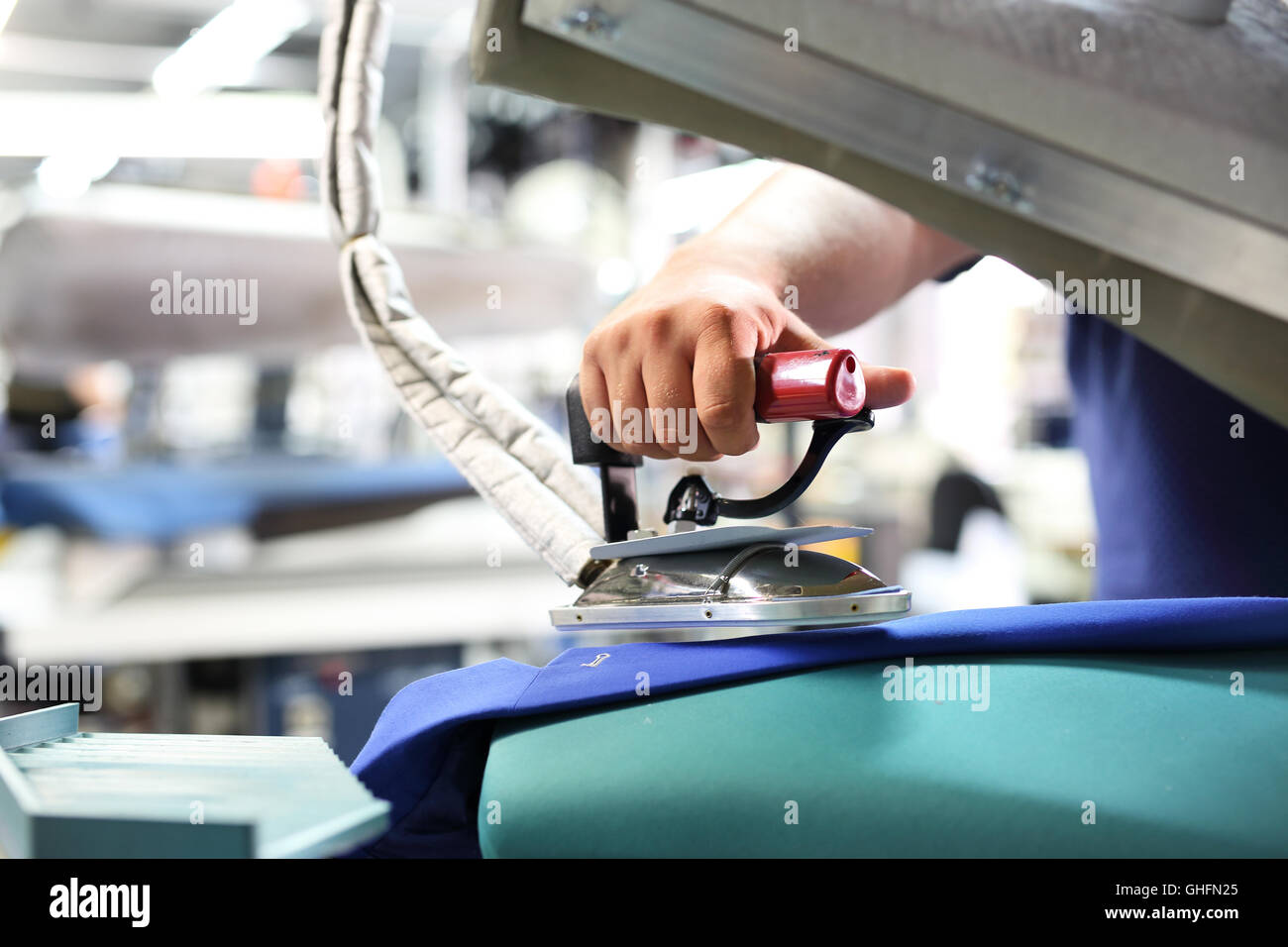 Presser in sewing clothes pressed Stock Photo - Alamy