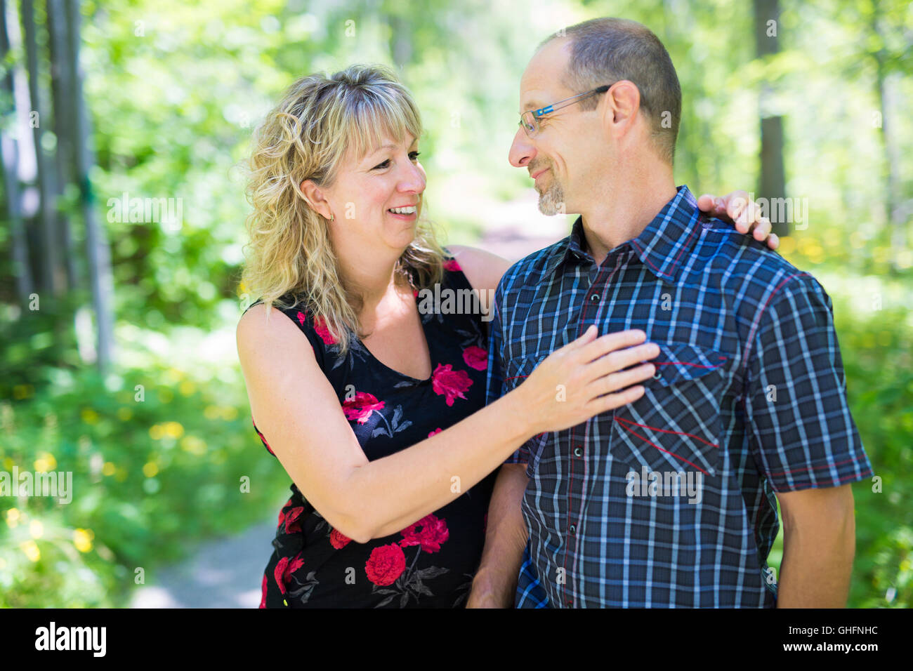 Happy adult couple in park Stock Photo - Alamy