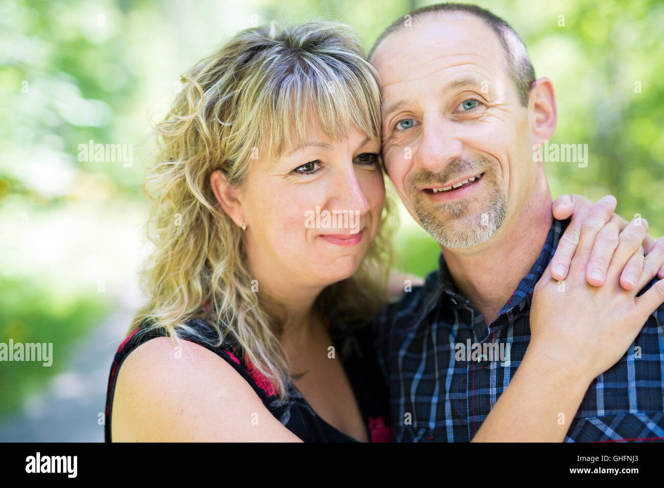 Happy adult couple in park Stock Photo - Alamy