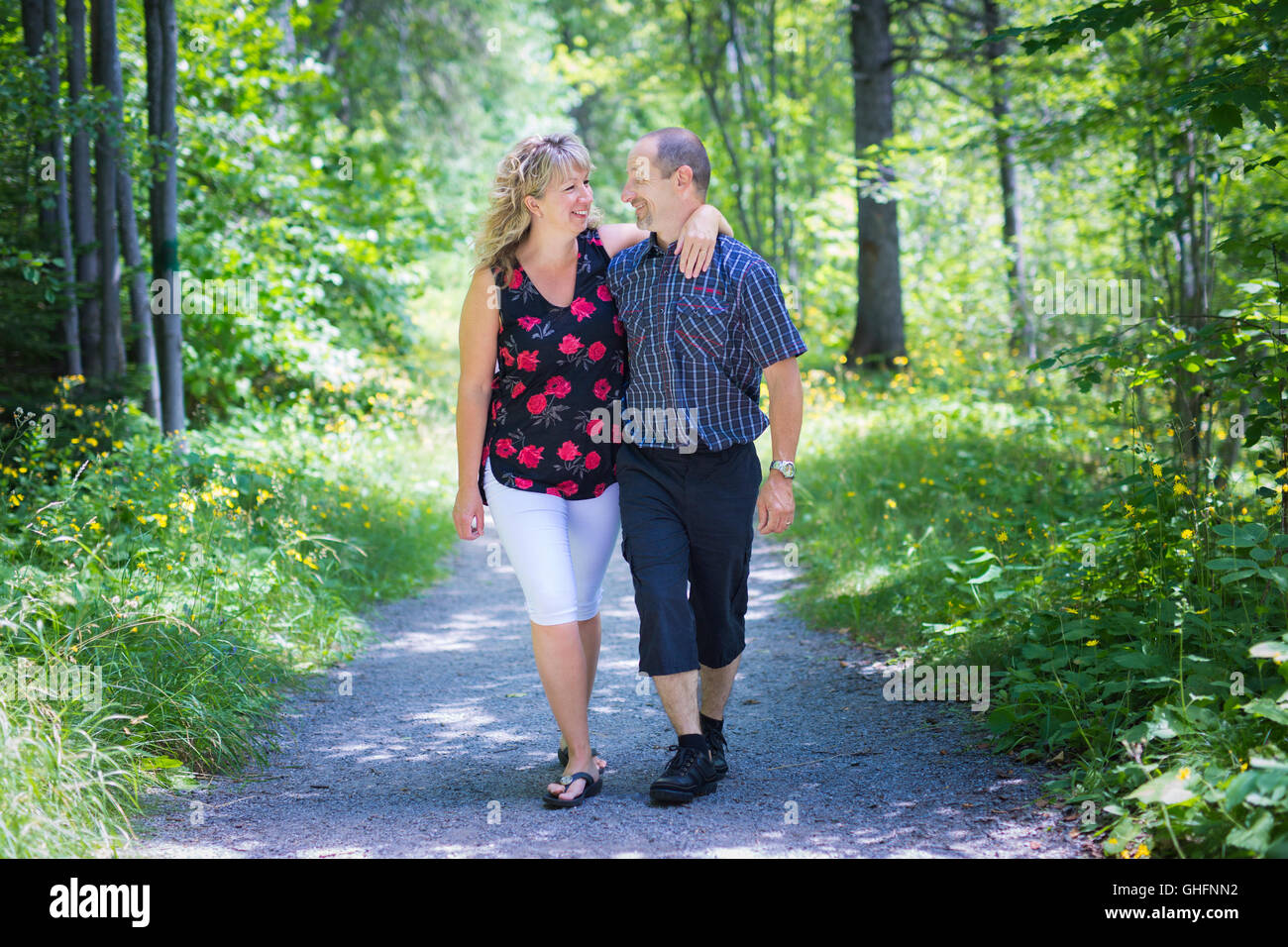 Happy adult couple in park Stock Photo - Alamy