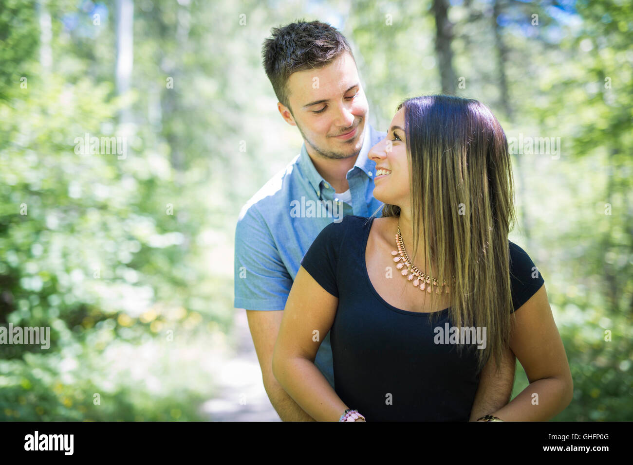 Happy loving young couple at the park Stock Photo - Alamy