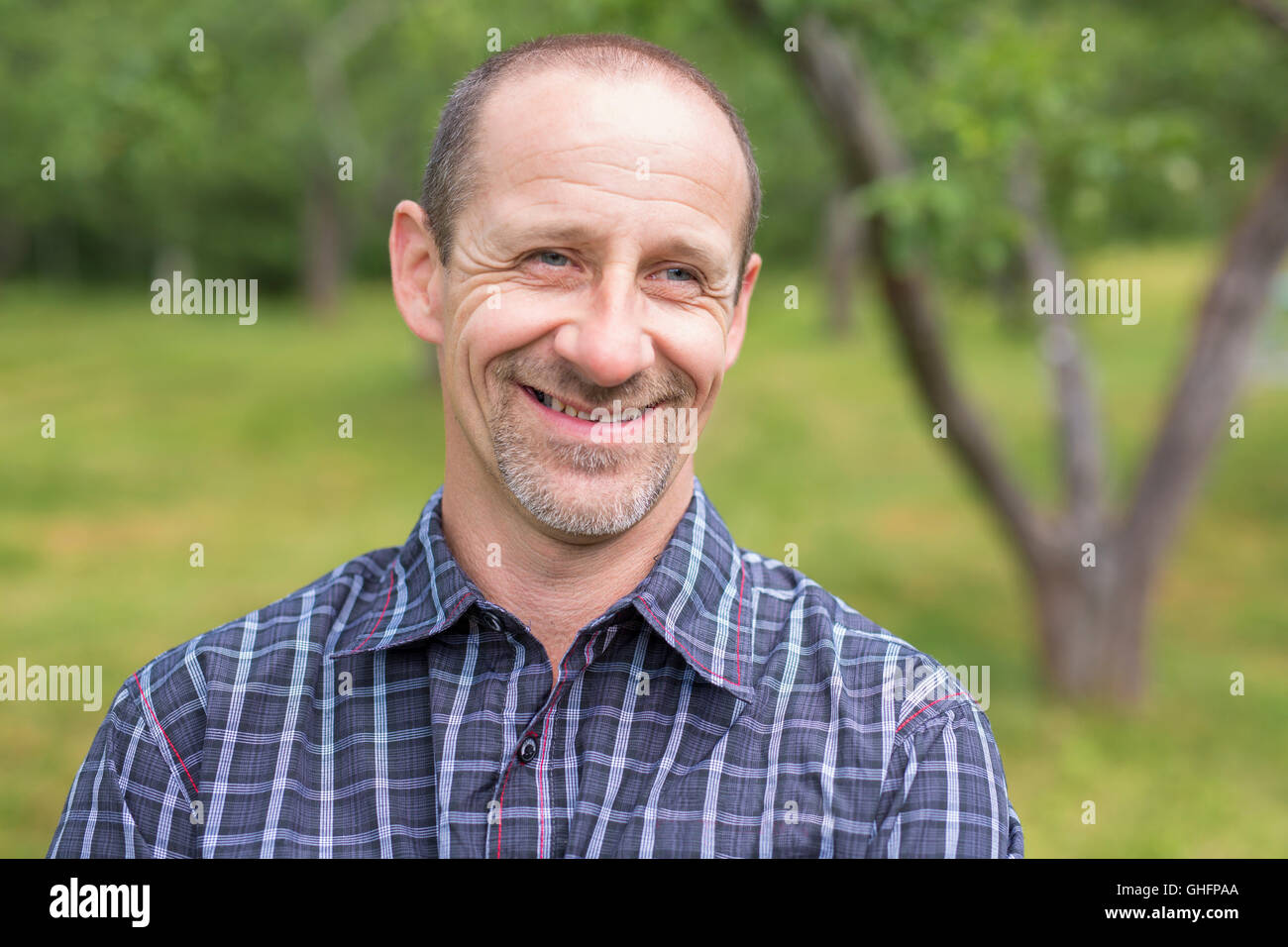 men outdoors smiling close to a tree in the forest Stock Photo - Alamy